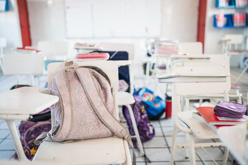 Backpacks Resting on Desks in an Empty Classroom after School Stock ...