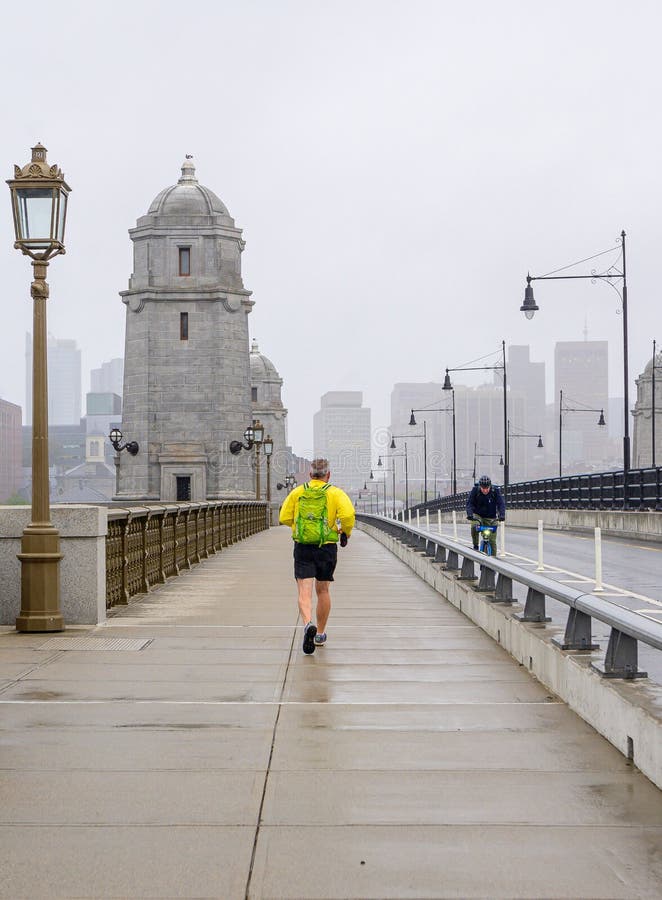 Backs Shot of a Man Running Along Longfellow Bridge in a Rainy Day ...
