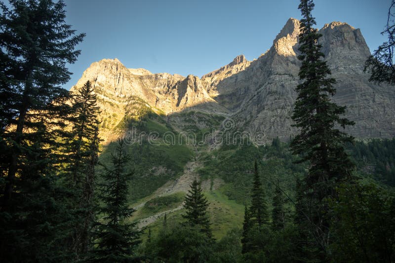 BackSide of Boulder Pass Catches the Morning Sun in Glacier Stock Photo ...