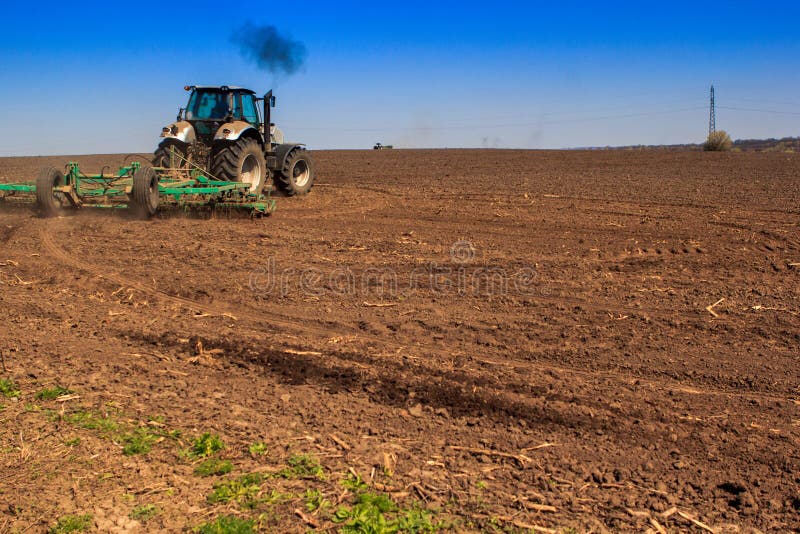 Backside View of Tractor Sowing in Field in Spring Stock Photo - Image ...