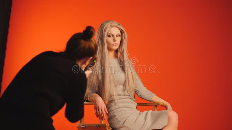 Backstage: Blonde Female Model Posing for Photographer in Red Studio ...