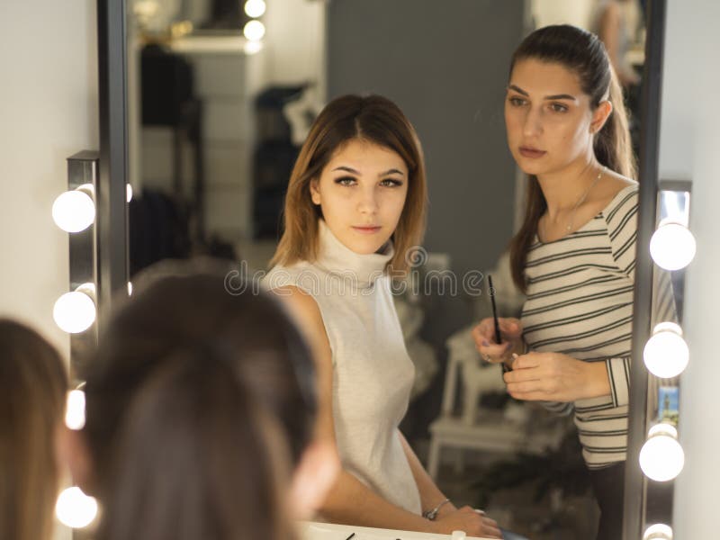 Backstage Makeup Artist and Model Look in the Dressing Mirror and ...