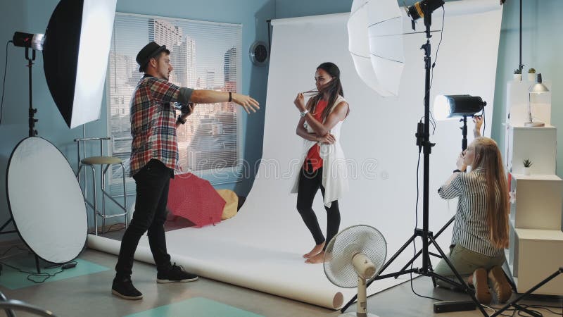 Backstage of the Photo Shoot: Assistant Adjusting the Spotlight Stock ...