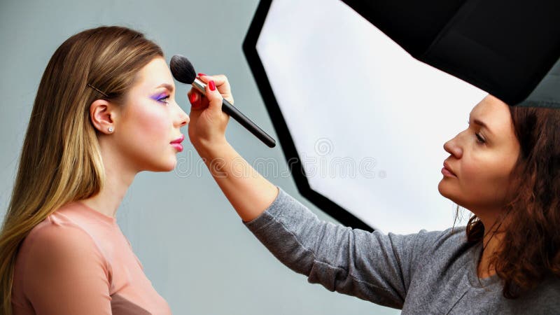 Make-up Artist Applies Makeup on Beautiful White Model. Stock Image ...
