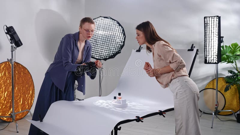 Photographer and Assistant Setting Up Perfume Photo Shoot Stock Video ...