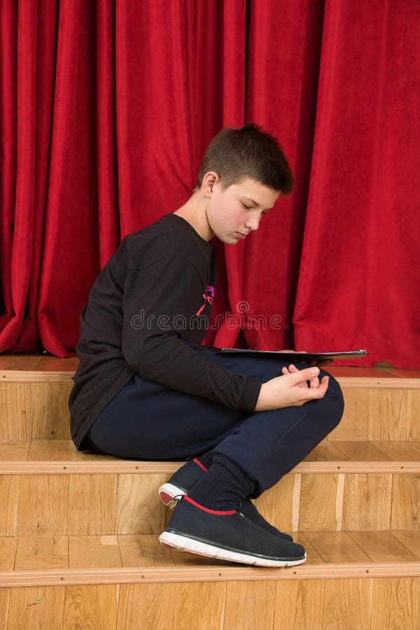 Backstage at the Stage, a Young Actor is Carefully Studying His Script ...