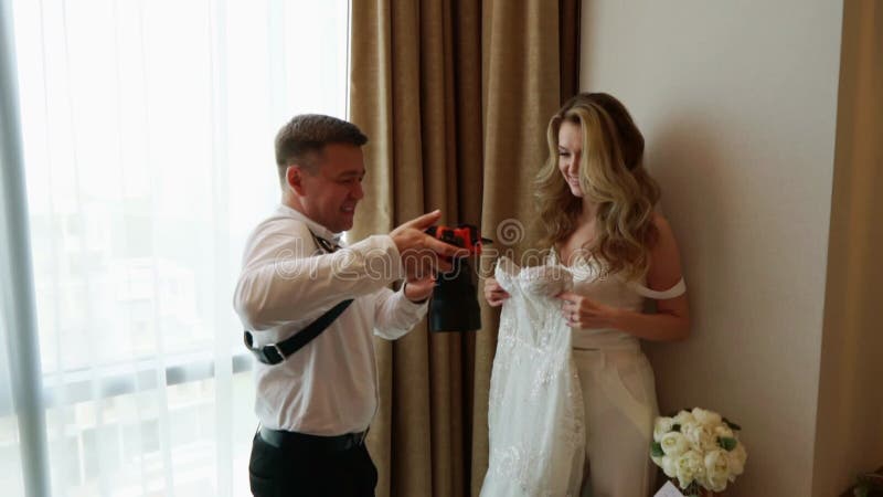 Backstage Wedding Shooting. the Bride with a Wedding Dress by the ...