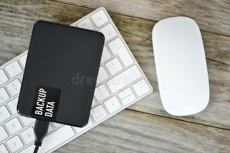 Backup Data with External Hard Disk Drive on White Computer Keyboard ...
