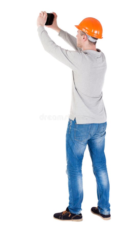 Backview of an Engineer in Construction Helmet Stands and Enjoys Stock ...