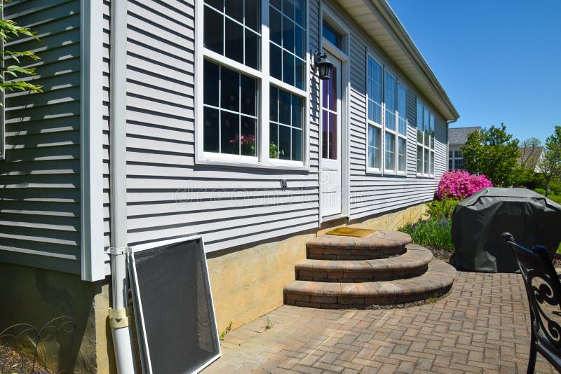 Backyard of a Gray House with a Brick Patio and Brick Steps Stock Image ...