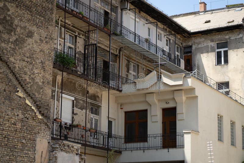 Backyard of an Old Poor Worn Building with Flats and Fancy Windows ...