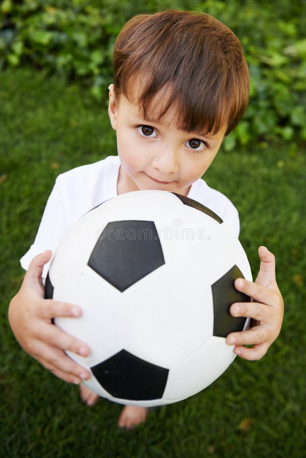 Backyard Soccer. a Sweet Little Boy with a Soccer Ball in the Backyard ...