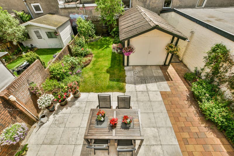 A Backyard with a Table and Chairs and a Garden Editorial Photo - Image ...