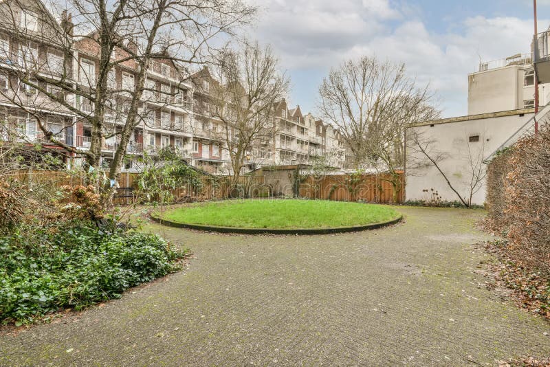 Backyard with round lawn stock image. Image of flowers - 244591175