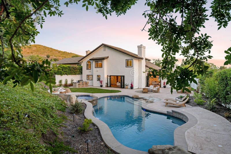 A Backyard View of a Modern House with a Swimming Pool and Lush ...