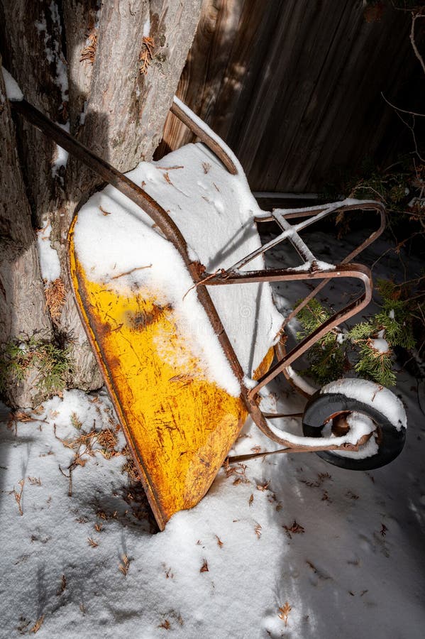 Backyard Wheel Barrow Stored for Winter with Snow Stock Image - Image ...