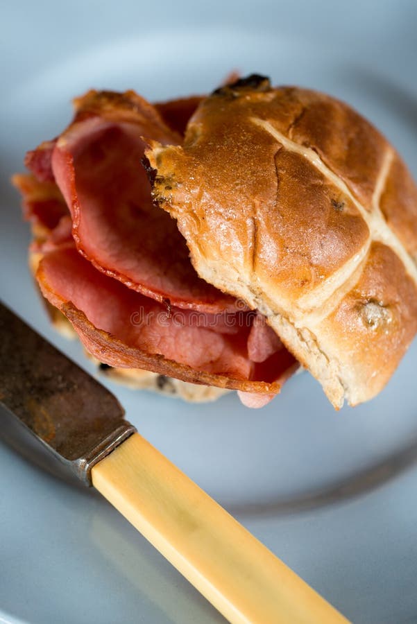 Bacon Cross Bun and Rusty Knife on Round Plate Stock Image - Image of ...