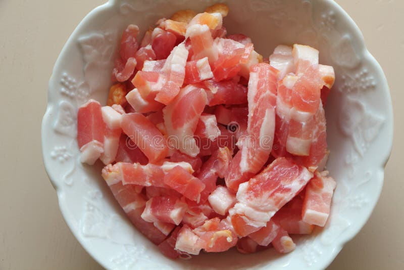Bacon cubes in a ramekin stock photo. Image of cube - 140560694