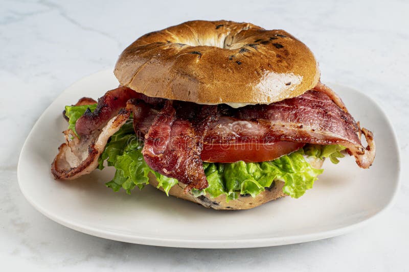 Bacon Lettuce and Tomato on a Blue Berry Bagel Stock Image - Image of ...