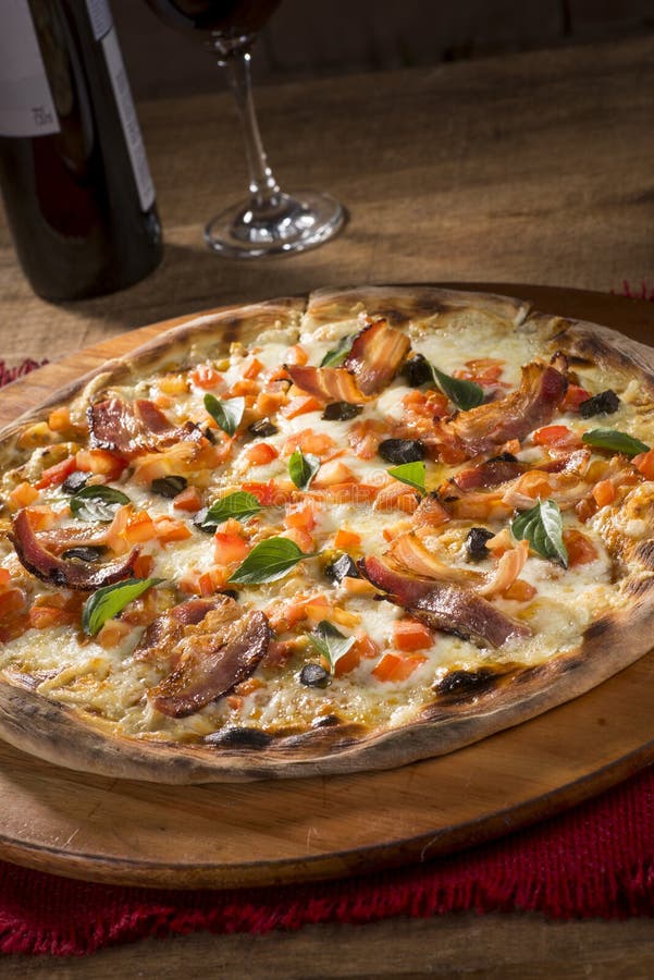 Bacon, Mozzarela, Mushroom and Tomato Pizza Over Rustic Setting Stock ...