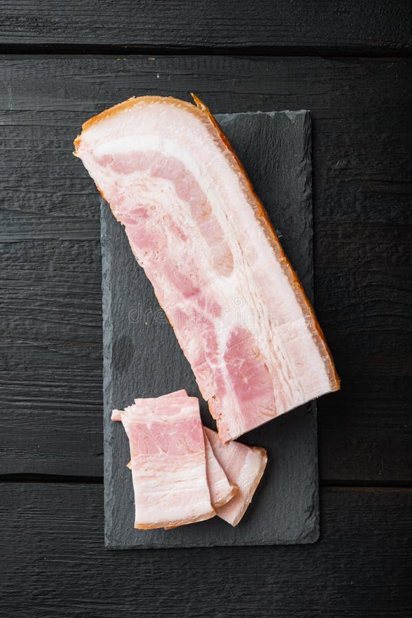 Bacon Pancetta Cut and Sliced on Black Wooden Table, Top View Stock ...