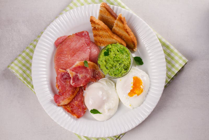 Bacon, Poached Eggs, Mashed Peas and Toasts on White Plate. Grilled ...
