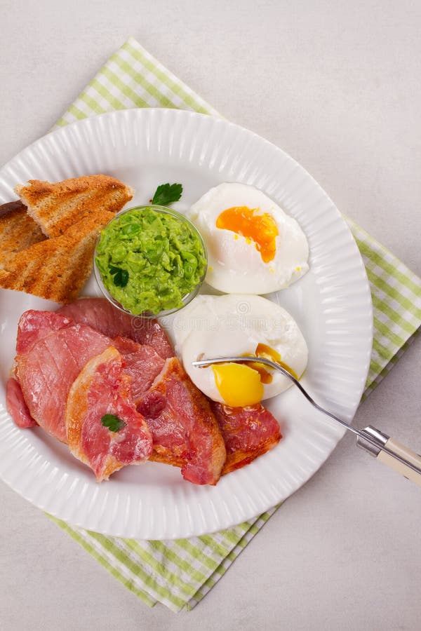 Bacon, Poached Eggs, Mashed Peas and Toasts on White Plate. Grilled ...