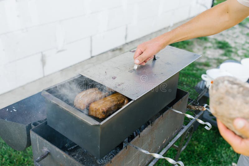 The Bacon is Smoked in a Smoke Box. a Man`s Hand Opens the Lid of the ...