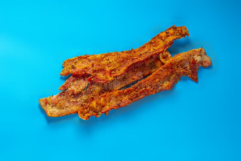 Bacon Strips on a Blue Background Stock Image - Image of shot, pork ...