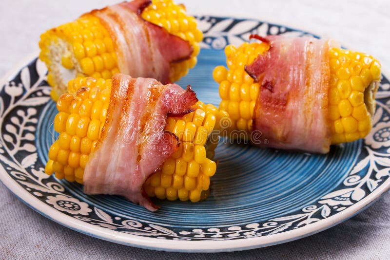 Bacon Wrapped Corn on Blue Plate. Stock Image - Image of canned, clean ...