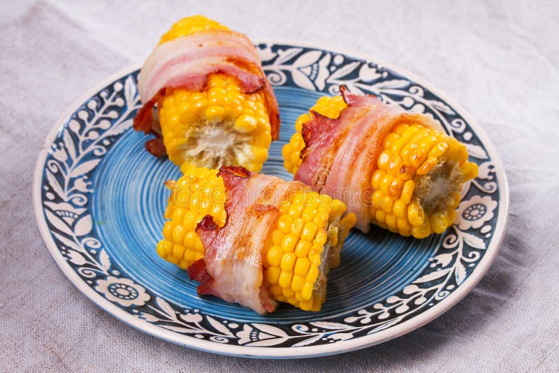 Bacon Wrapped Corn on Blue Plate. Stock Image - Image of butter ...