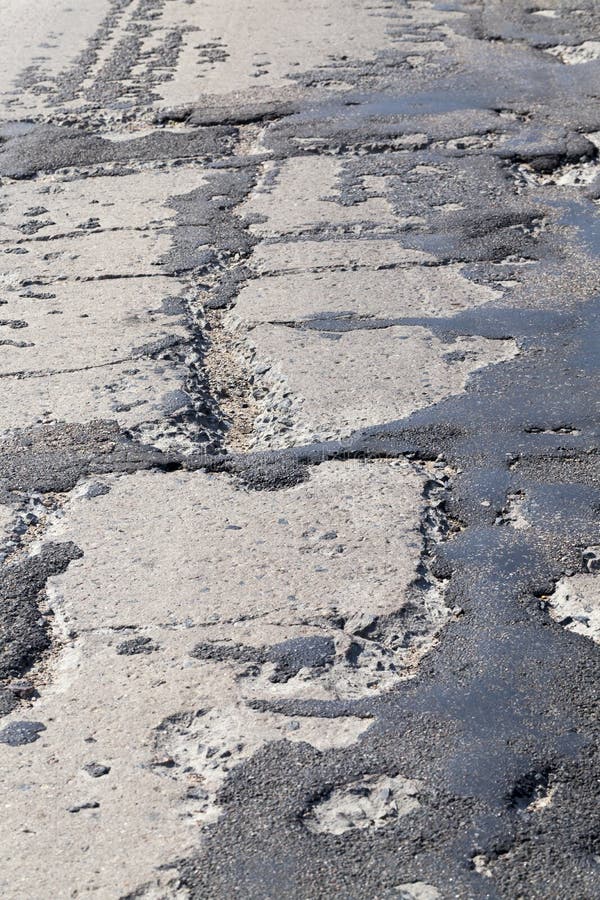 A Bad Asphalt Road that Has Been Repaired Many Times Stock Photo ...