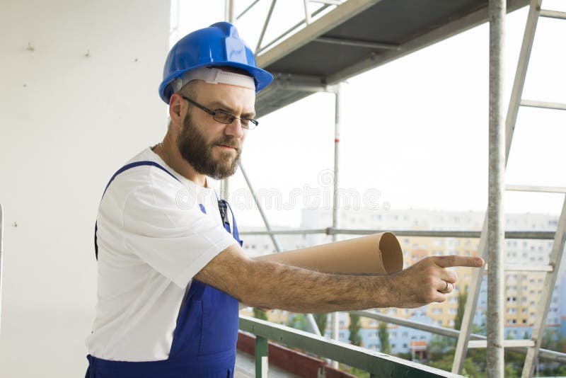Construction Worker in Working Outfit and in Helmet Standing at High ...