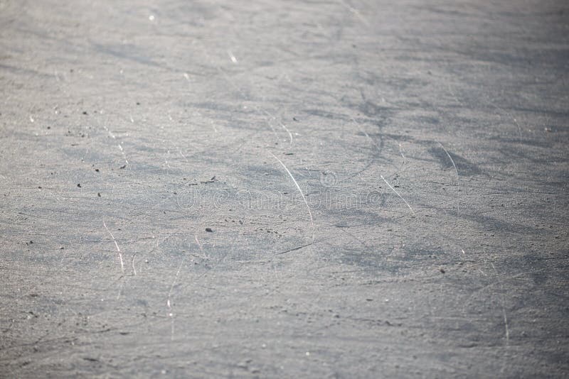 Bad Ice at the City Rink in Sunny Spring Day. Many Bands, Cuts, Cracks ...