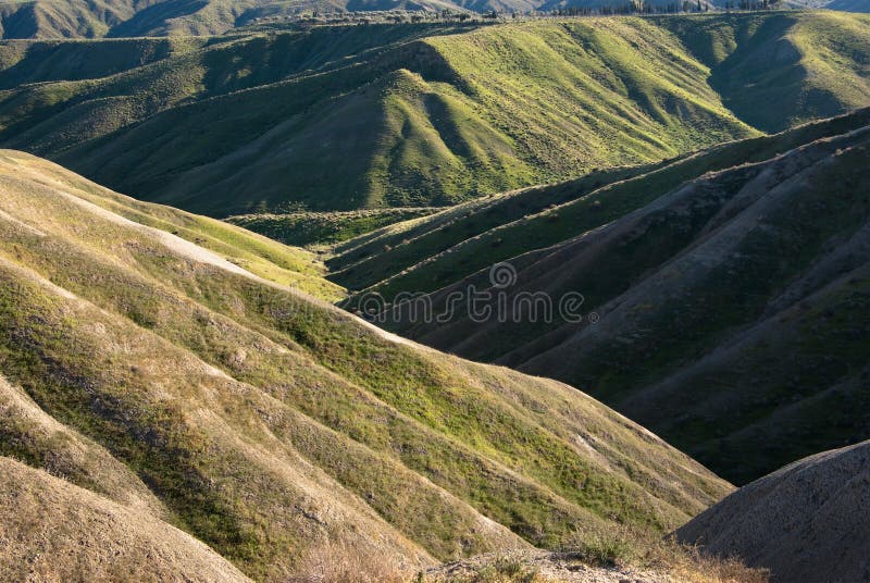 Badlands Covered by Green Grass Stock Photo - Image of slope, hill ...