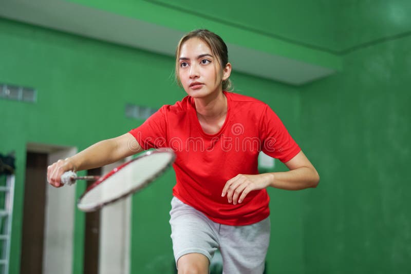 Badminton Player Holding Racket in Ready Position on Court Stock Photo ...