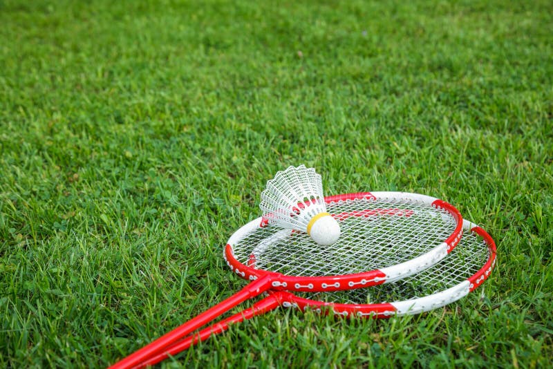 Badminton Racquets with Shuttlecock on Grass Stock Photo - Image of ...
