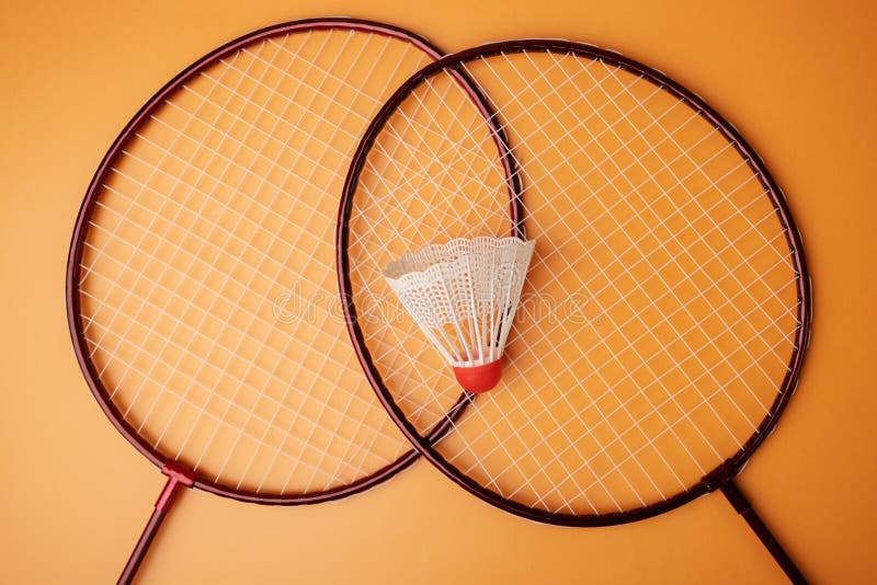 Badminton, Shuttlecock and Two Rackets on Orange Background Stock Photo ...