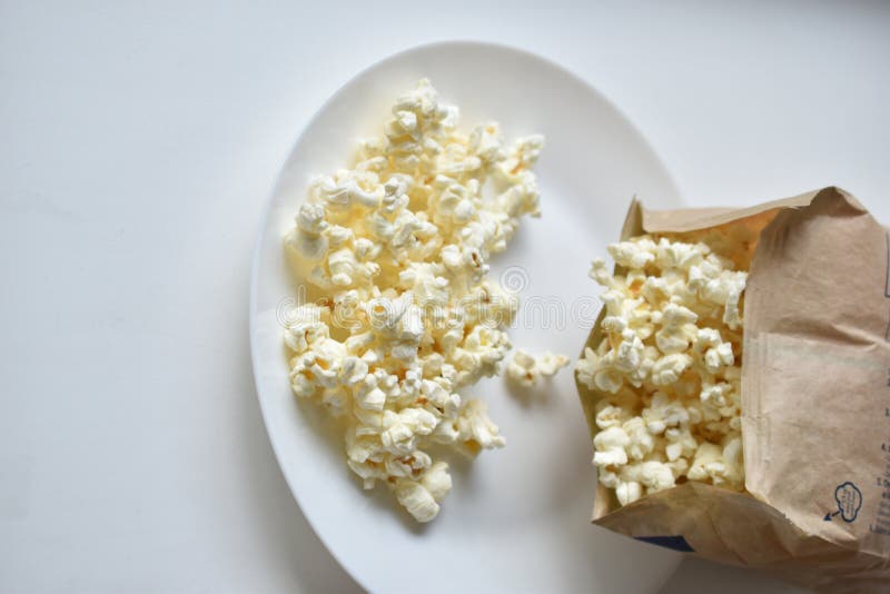 A Bag of Popcorn Open on a Plate in the Kitchen Stock Image - Image of ...