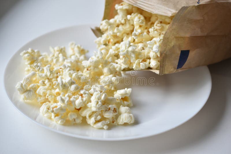 A Bag of Popcorn Open on a Plate in the Kitchen Stock Photo - Image of ...