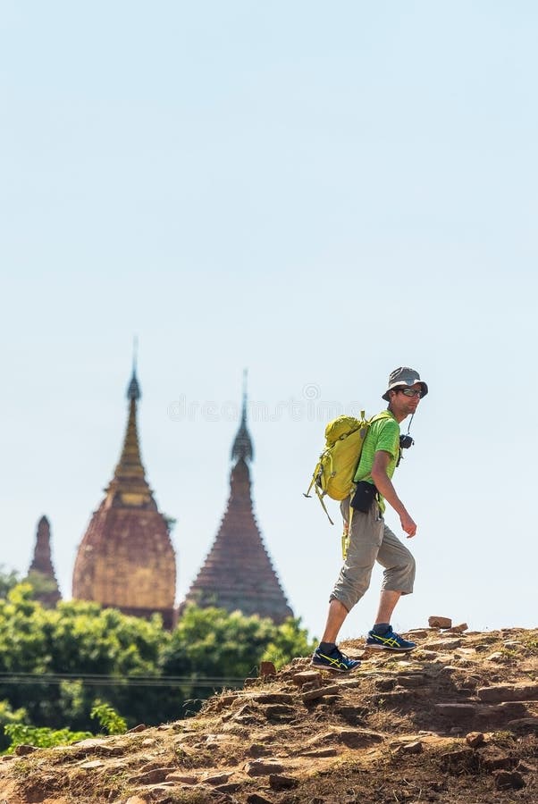 BAGAN, MYANMAR - DECEMBER 1, 2016: a Man with a Backpack is Climbing a ...