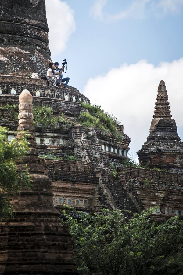 Two People Sitting on a Tall Pagoda in Bagan Editorial Photo - Image of ...