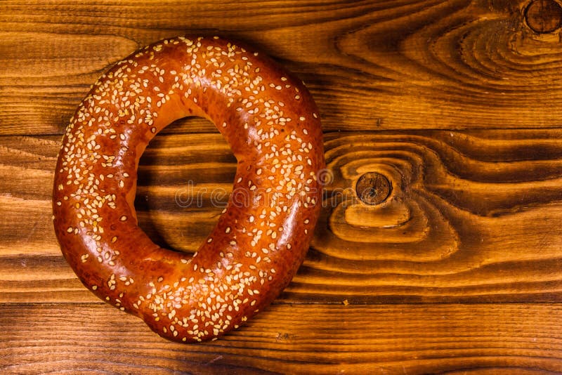 Bagel with Sesame Seeds on Wooden Table. Top View Stock Image - Image ...