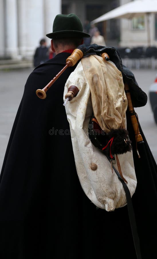 Bagpiper with a Black Cape and the Bagpipes on the Shoulders Editorial ...