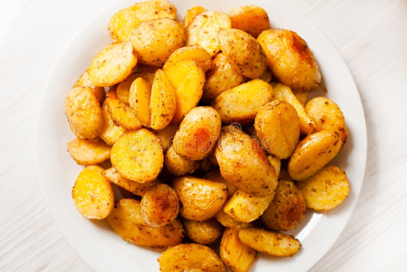 Baked Appetizing Crispy Potato on White Plate on the Table. Top View ...