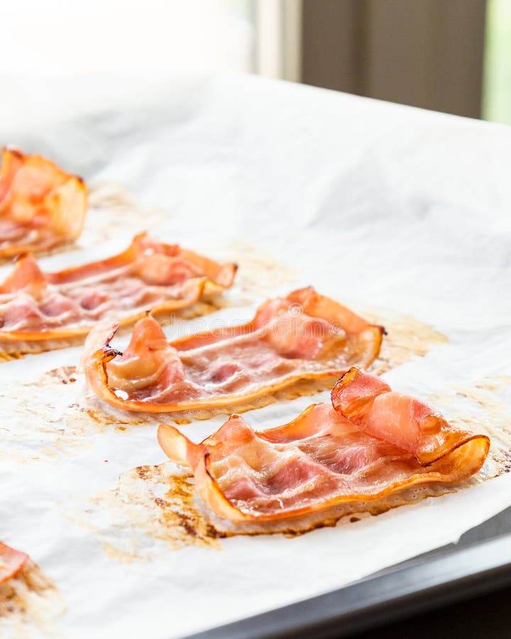 Baked Bacon Strips on Parchment Paper CloseUp Stock Image - Image of ...