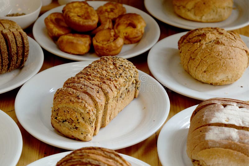 Baked Bread on White Plate and Wooden Table Stock Image - Image of ...