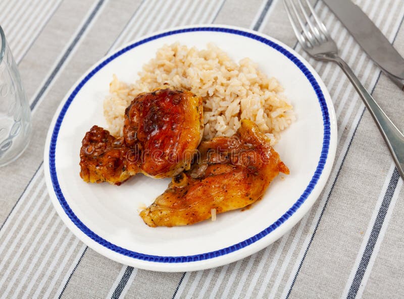 Baked Chicken Thighs Served with Rice on Plate Stock Photo - Image of ...