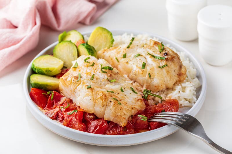 Baked Cod Fish, with Tomato, Brussel Sprouts and Boiled Rice. Stock ...