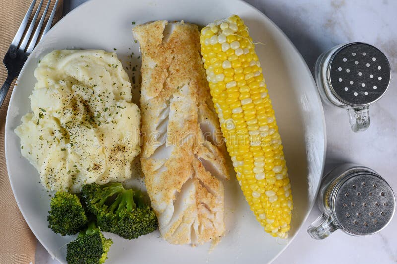 Baked Cod Served with Corn and Mashed Potatoes Stock Image - Image of ...
